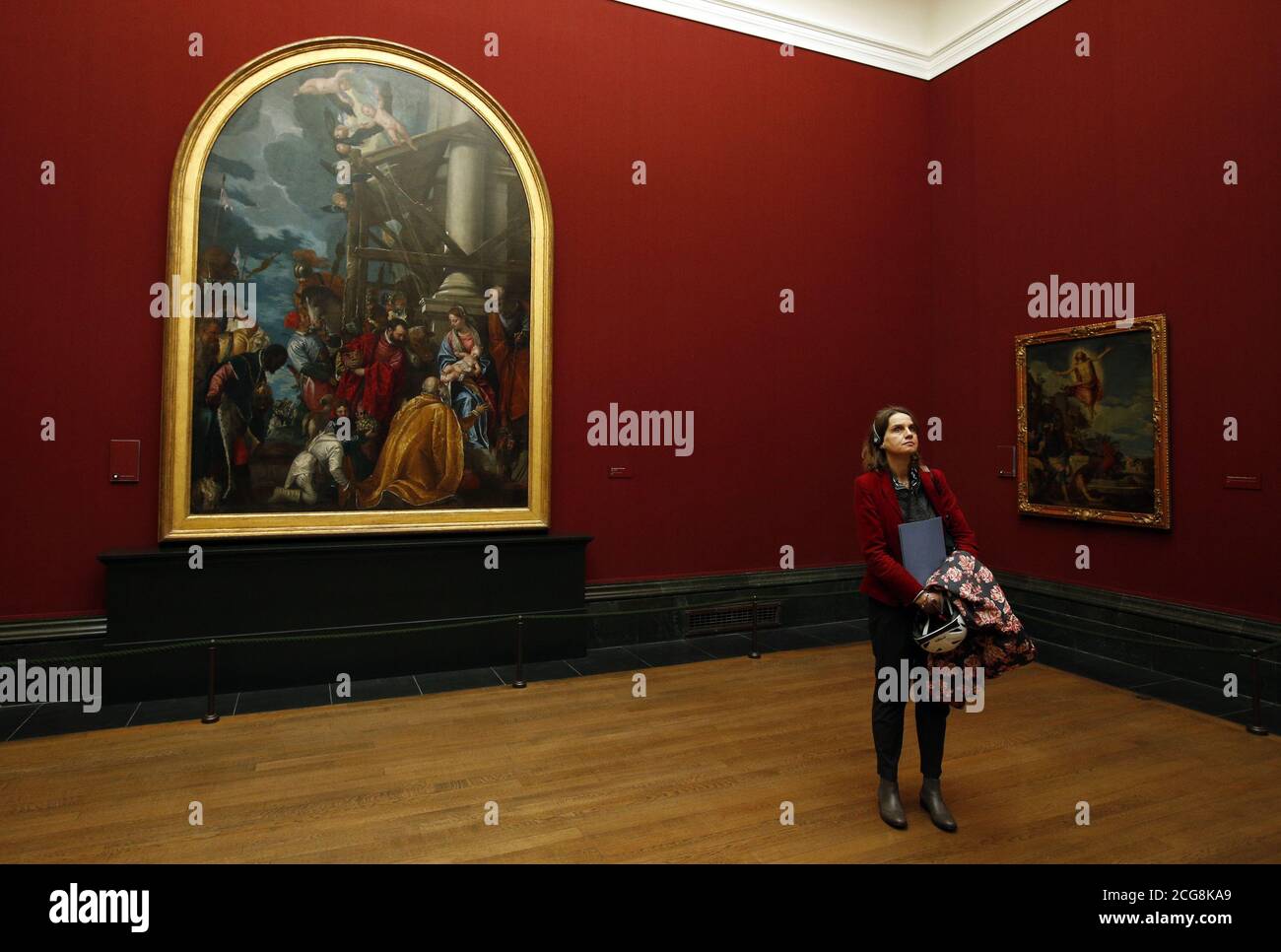 A visitor looks at works by Paolo Veronese while standing in front of ...