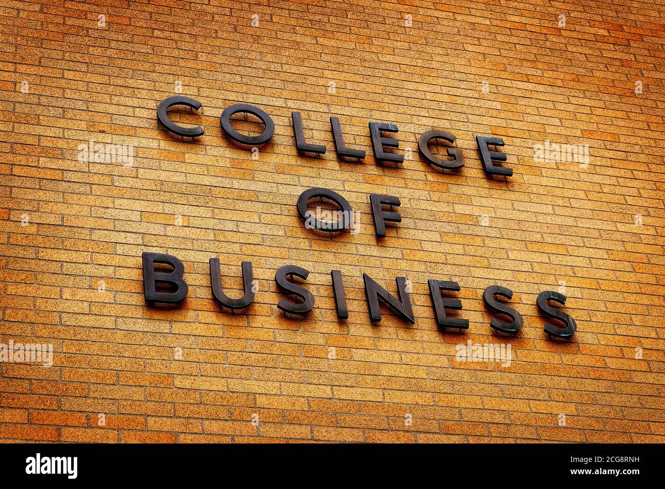 Detail of College of Business sign education at University Brick Wall ...