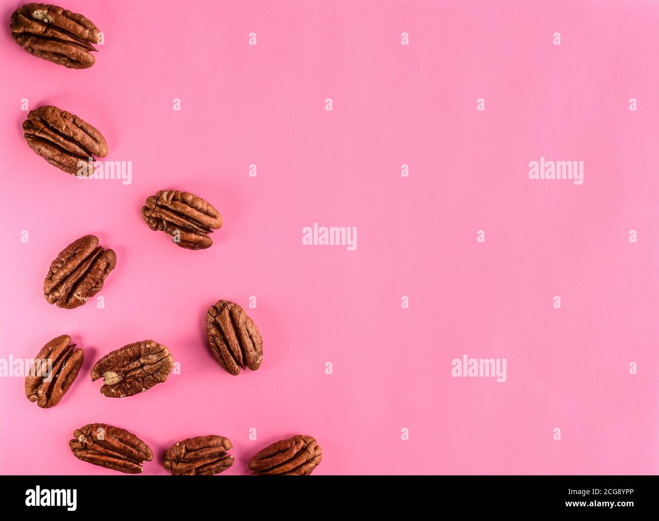 Walnuts on pink background, empty space Stock Photo - Alamy