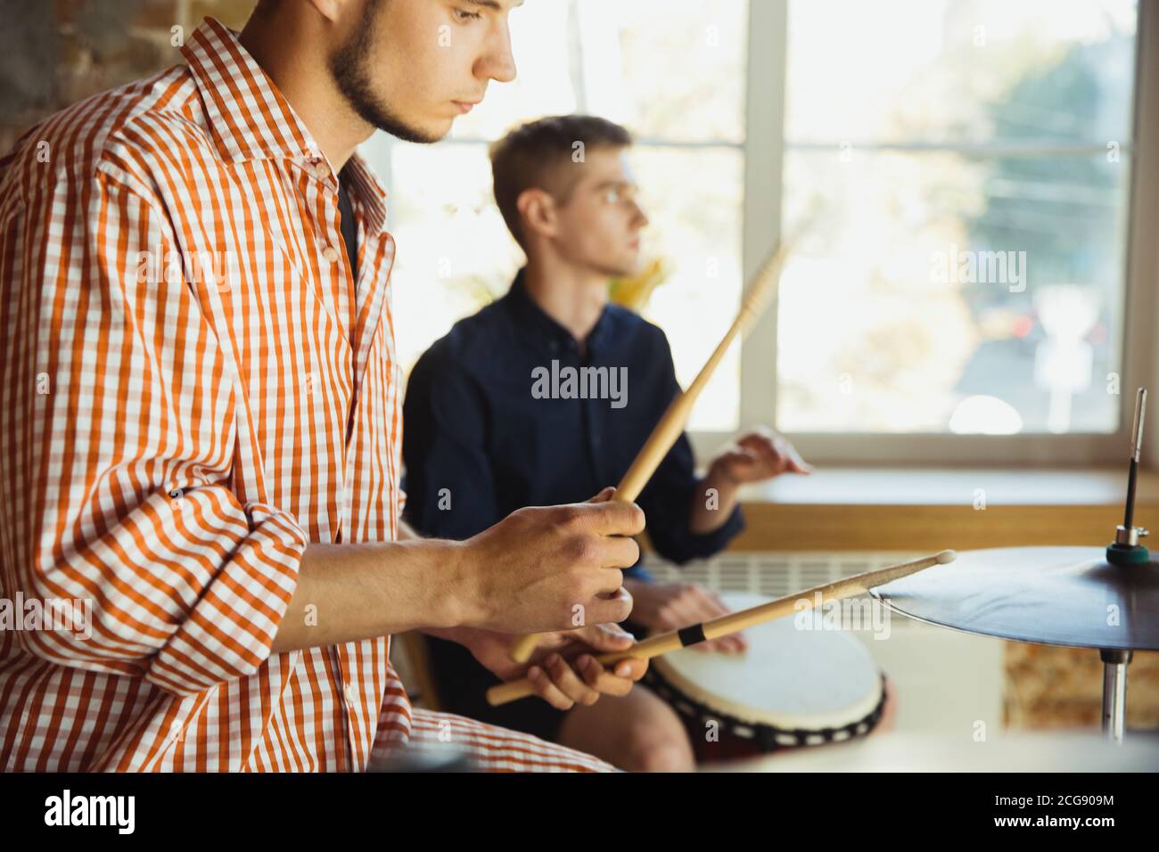 Inspiration. Musician band jamming together in art workplace with ...