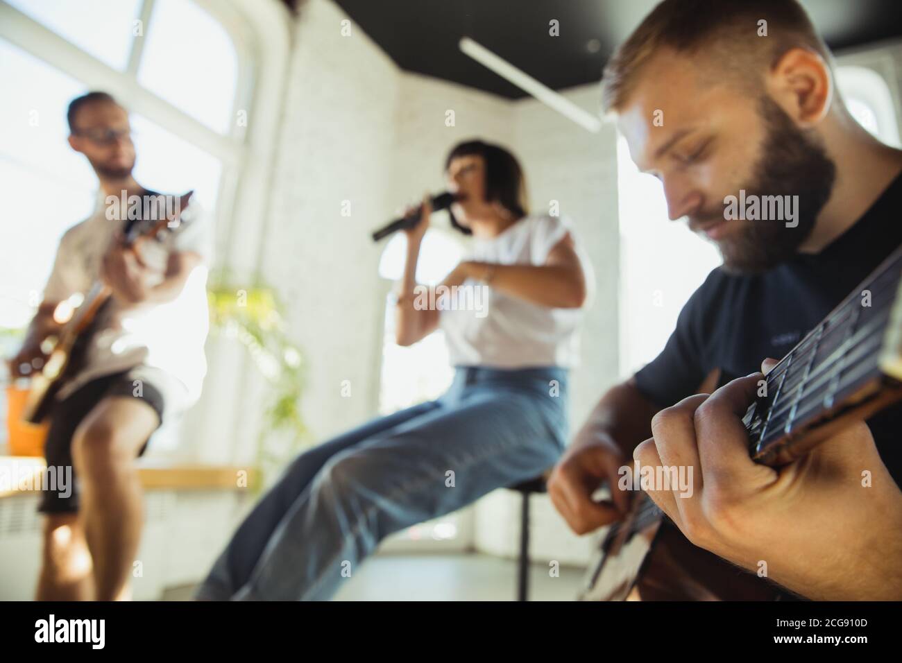 Rhythm. Musician band jamming together in art workplace with ...