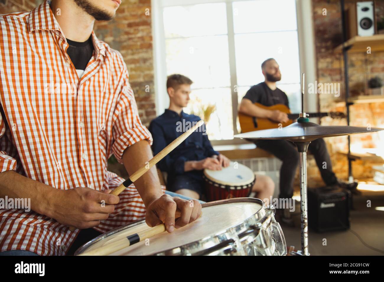 Rhythm. Musician band jamming together in art workplace with ...