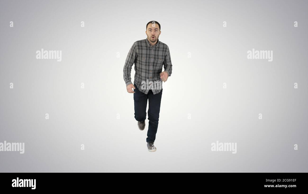 Man starting to run in casual clothes on gradient background Stock ...