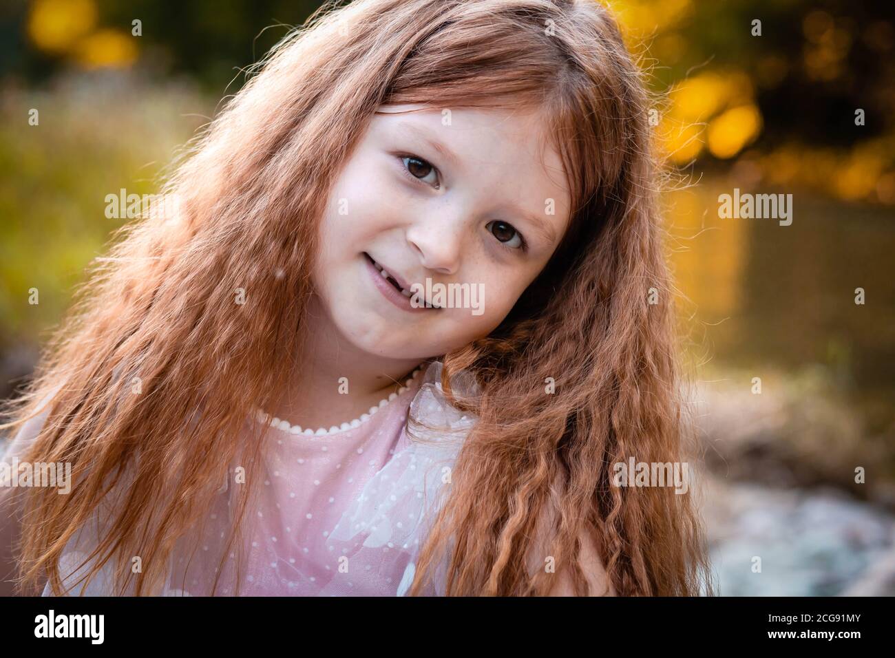 Adorable, ginger little girl smiles and shows missing front teeth Stock ...