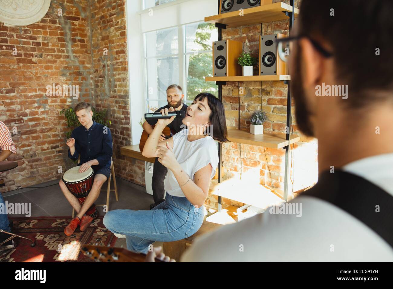 Rhythm. Musician band jamming together in art workplace with ...