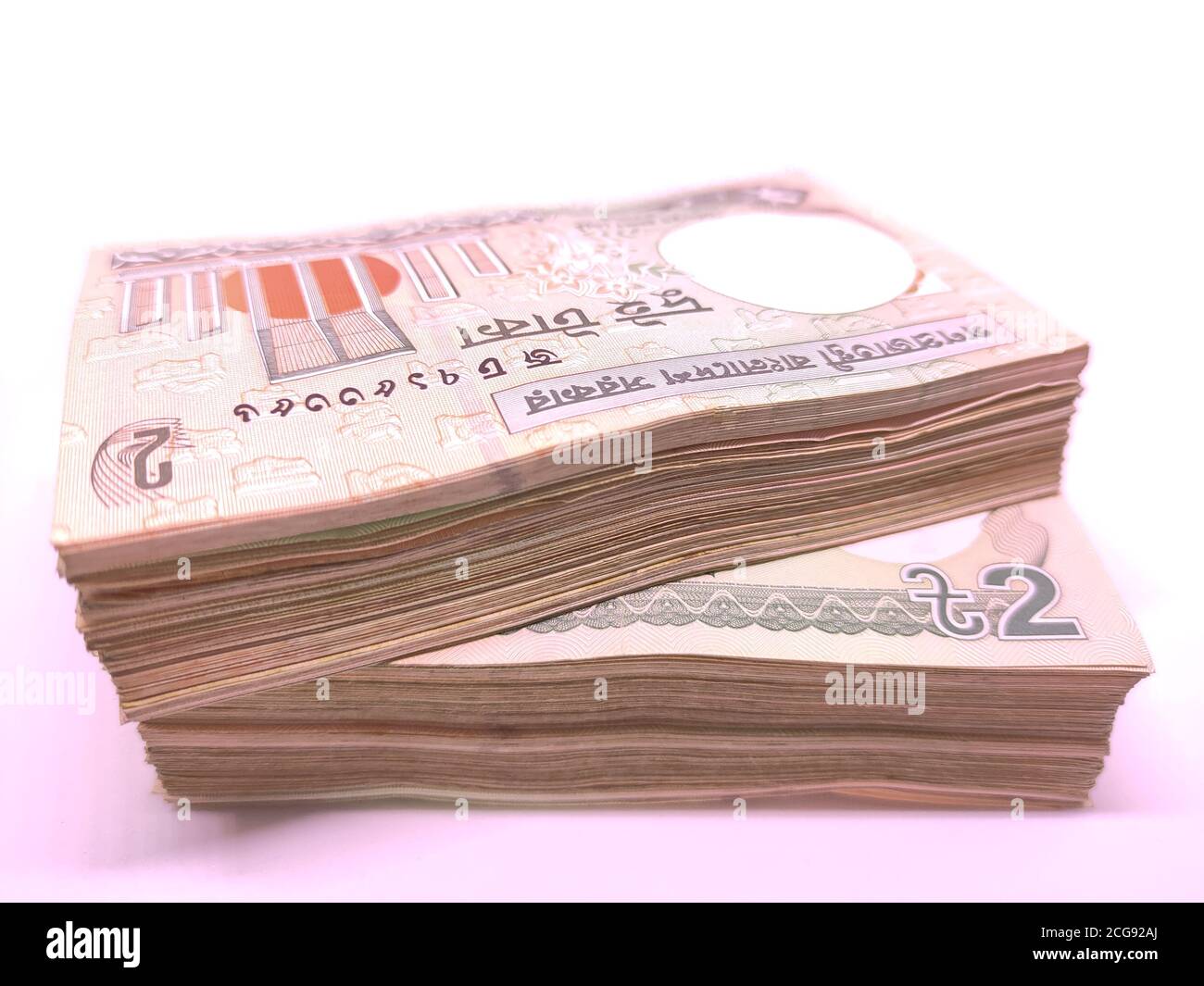 Stacks of two taka Bangladeshi banknotes close-up isolated on white ...