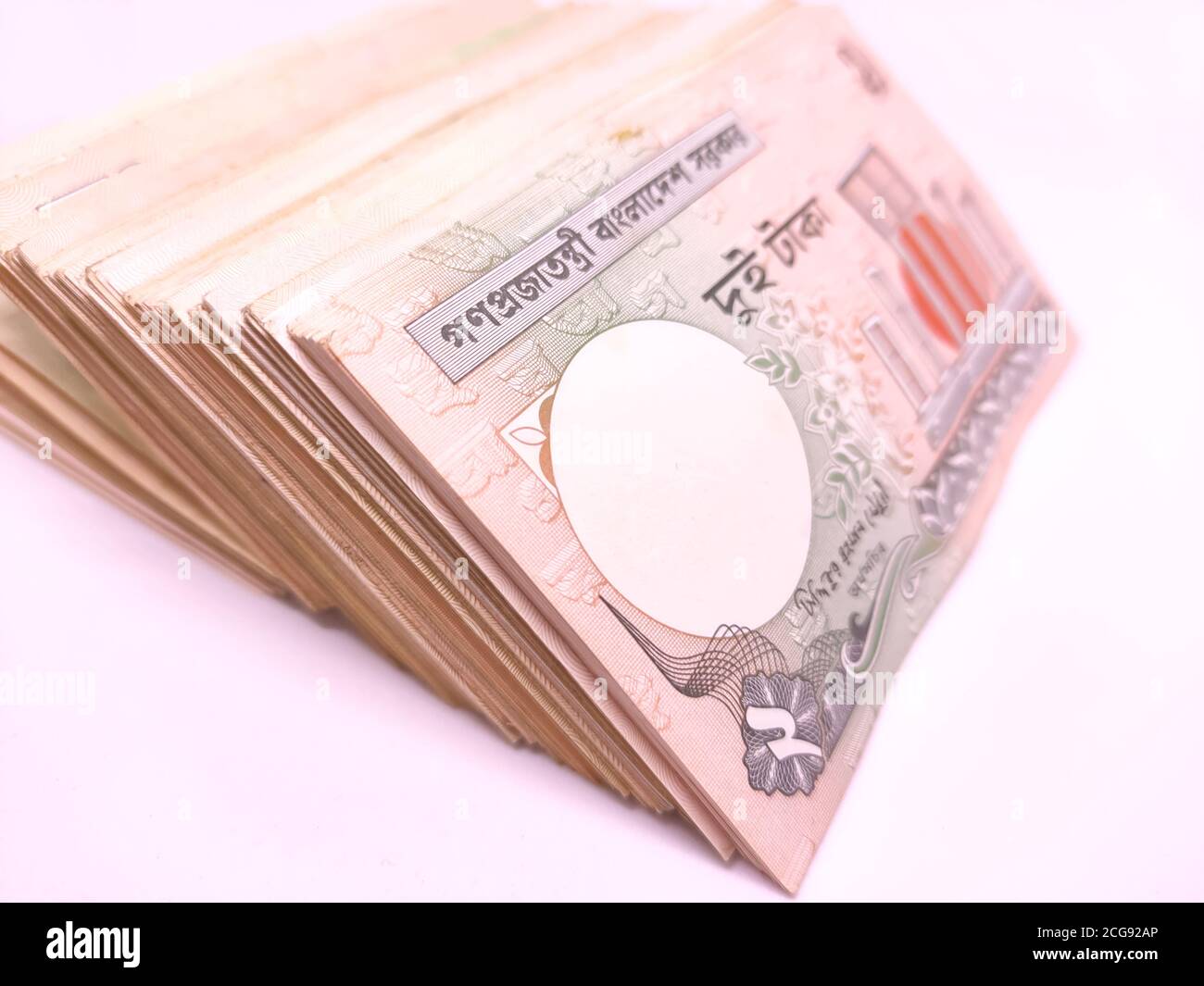 Stacks of two taka Bangladeshi banknotes close-up isolated on white ...