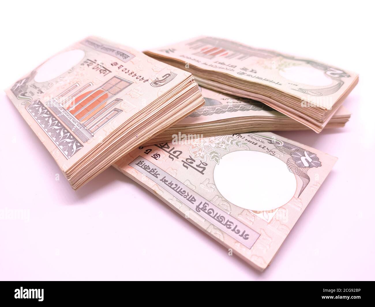 Stacks of two taka Bangladeshi banknotes close-up isolated on white ...