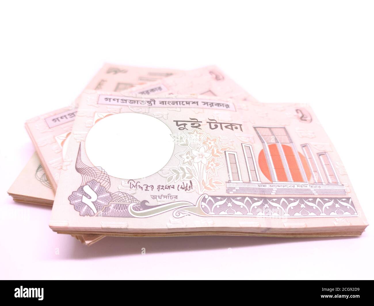 Stacks of two taka Bangladeshi banknotes close-up isolated on white ...