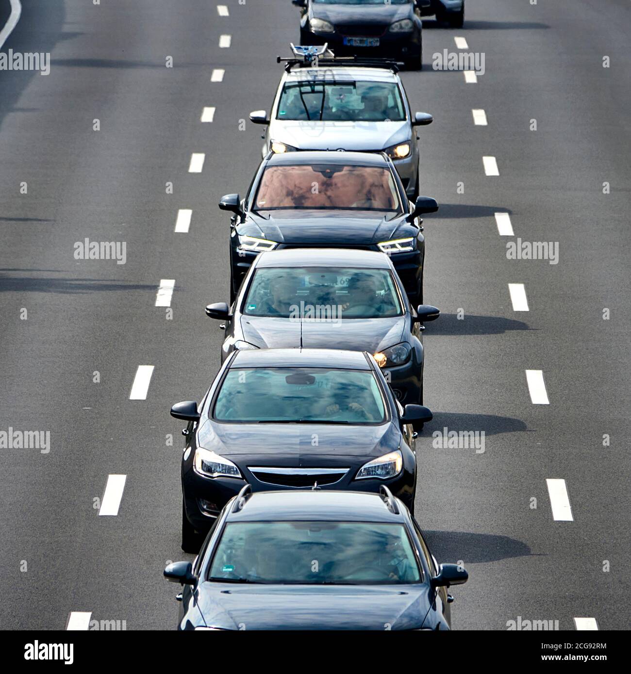 Cars on the German highway behind each other on the middle strip of the ...