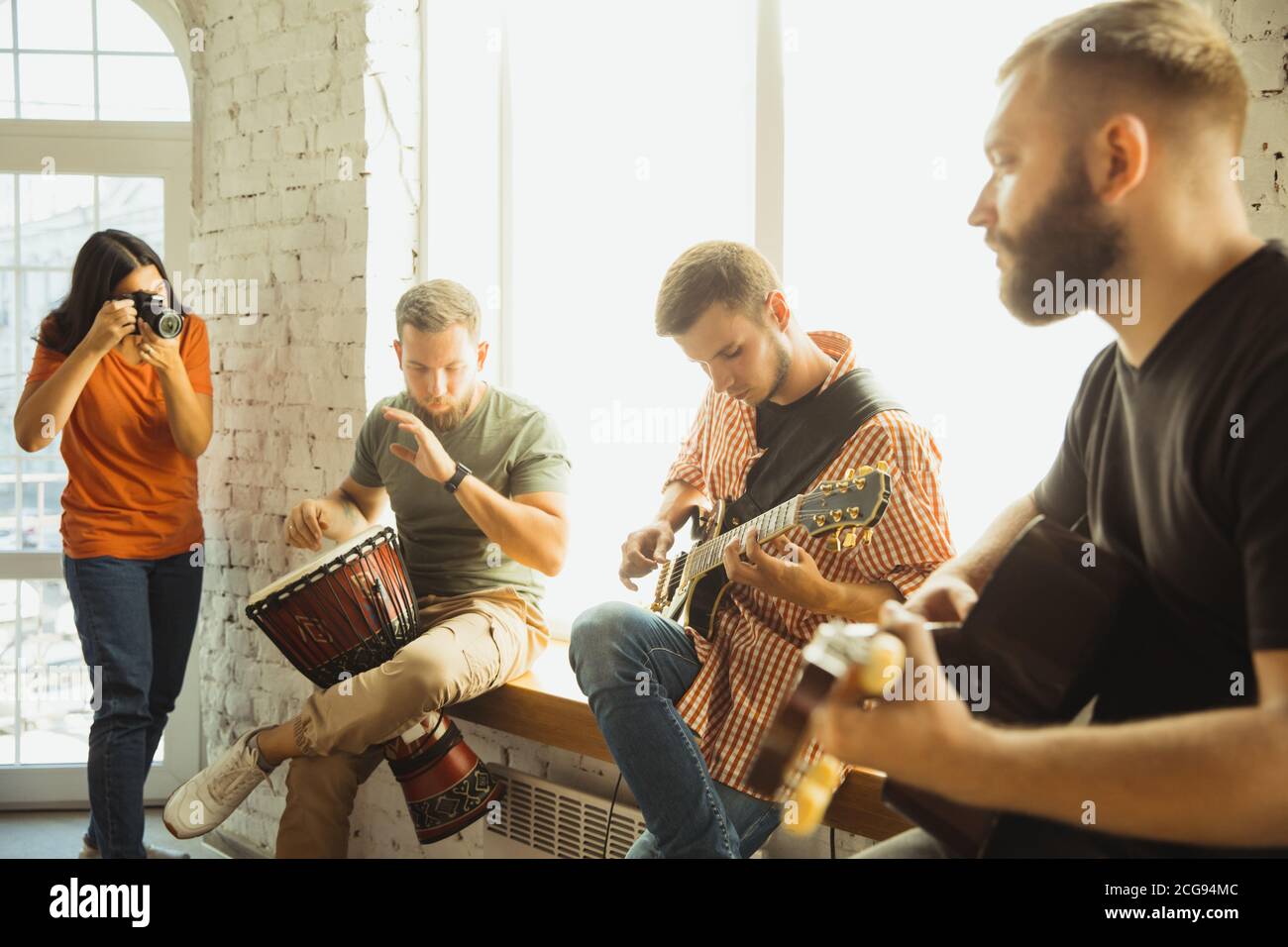 Session. Musician band jamming together in art workplace with ...