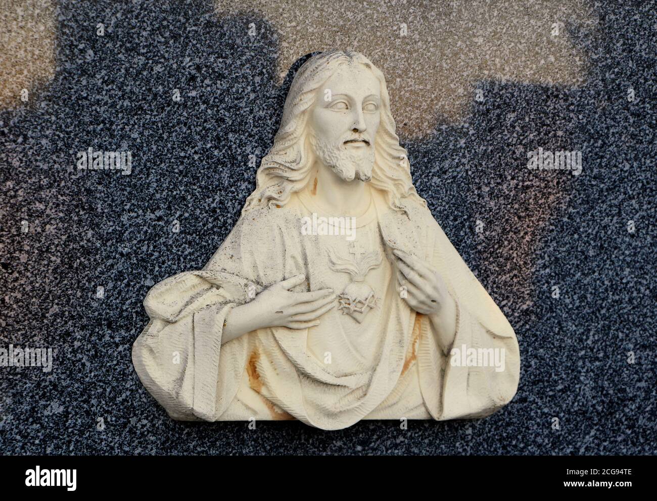 Grave Jesus Christ sculpture on a dark grey marble background in ...