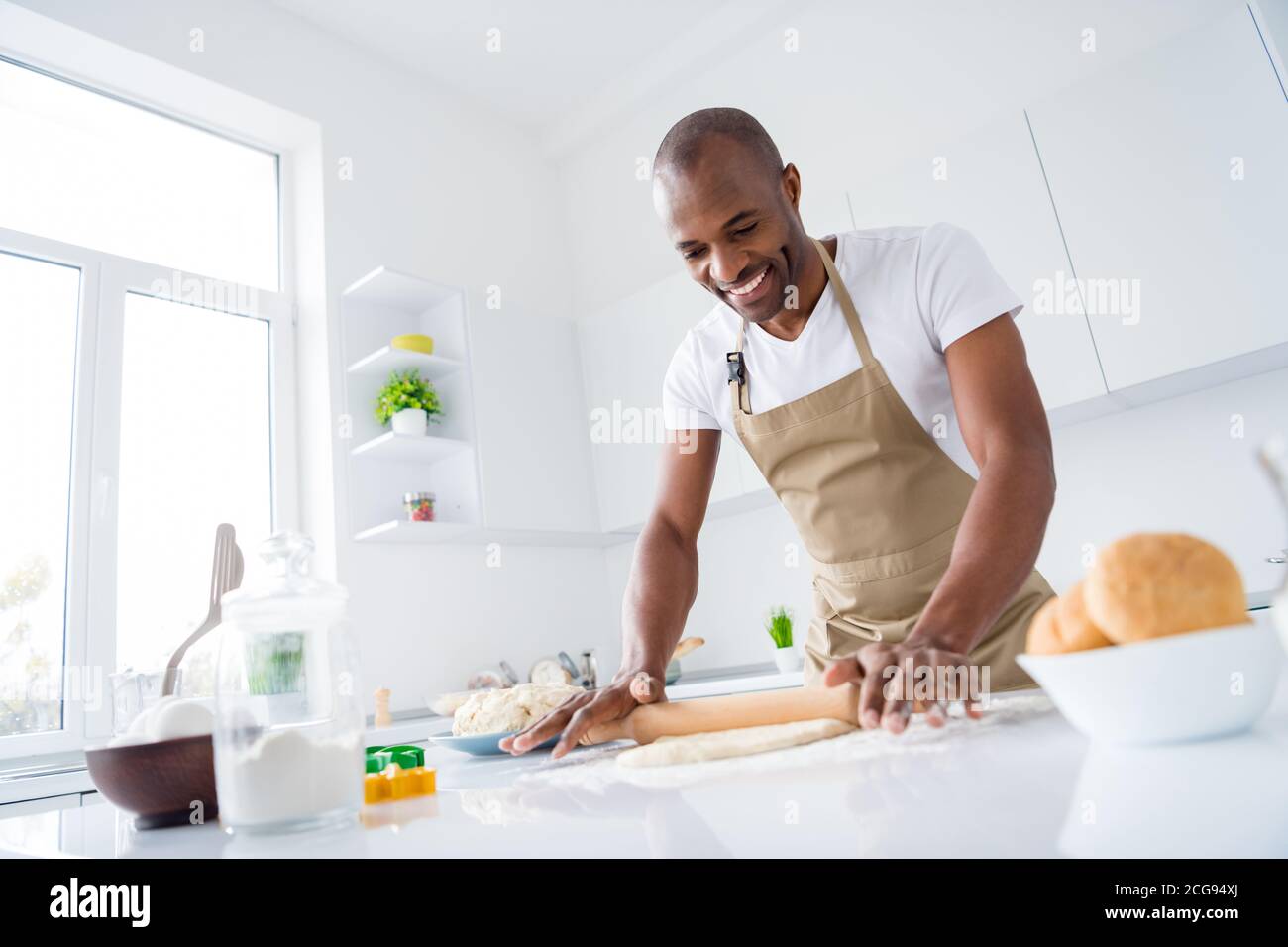 Portrait of his he nice attractive cheerful guy making handmade bread ...