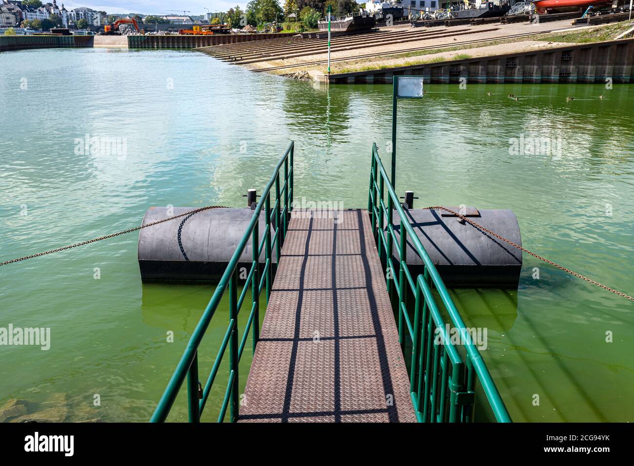 A metal platform protruding from the river bank on air tanks, a pier to ...