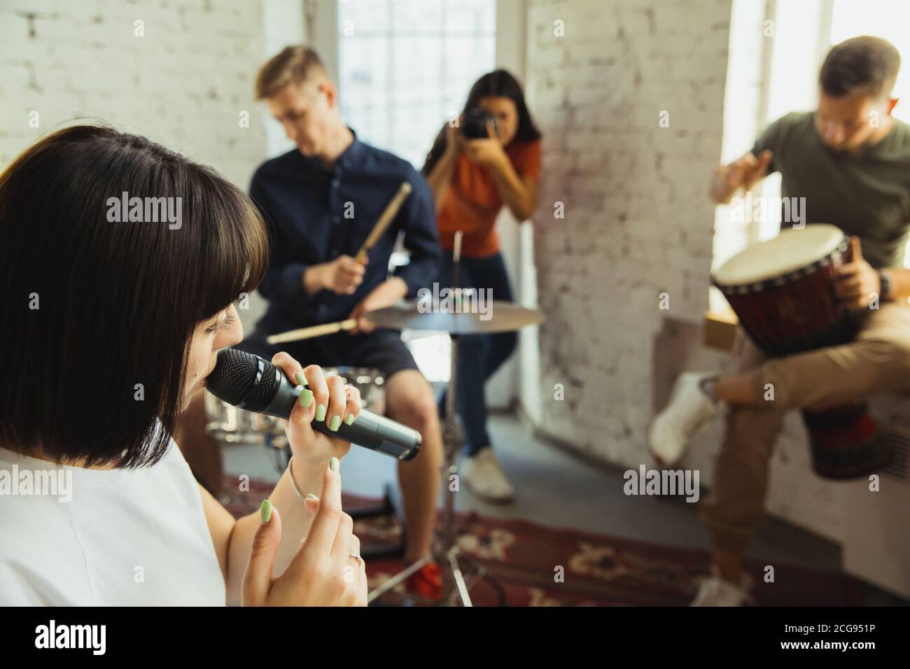 Session. Musician band jamming together in art workplace with ...