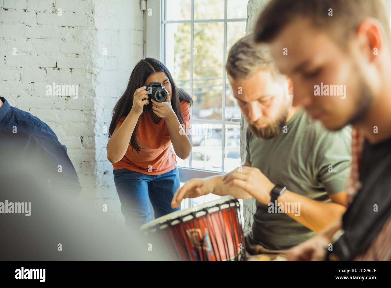 Session. Musician band jamming together in art workplace with ...