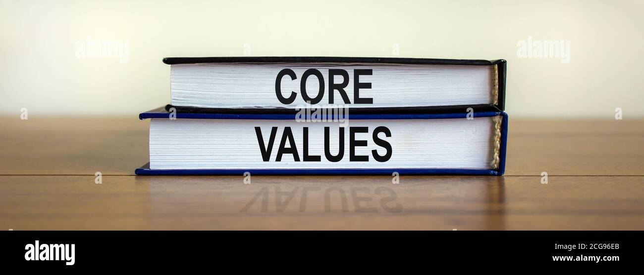 Books with text 'core values' on beautiful wooden table. White ...