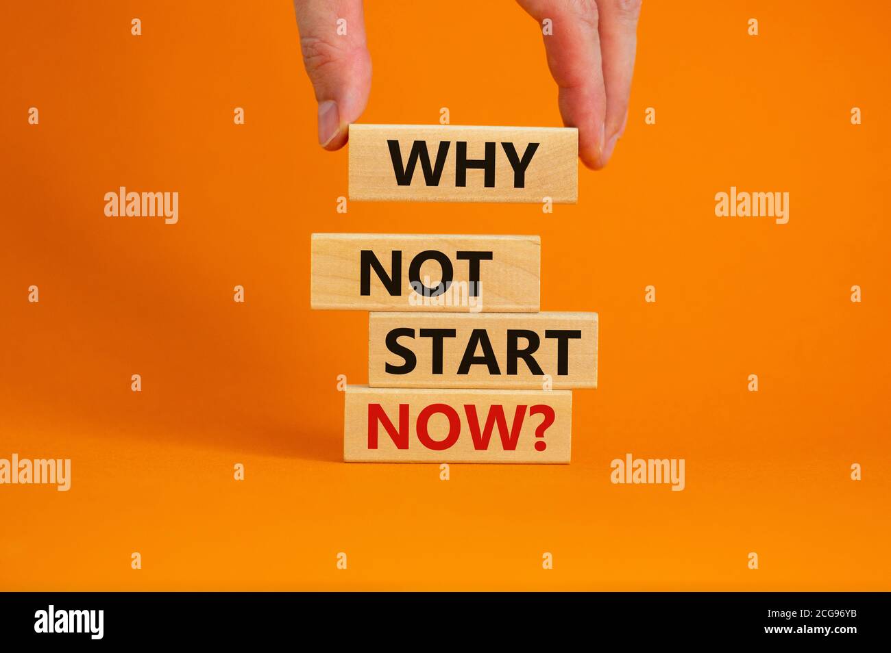 Male hand placing a block with word 'why' on a blocks tower with words ...