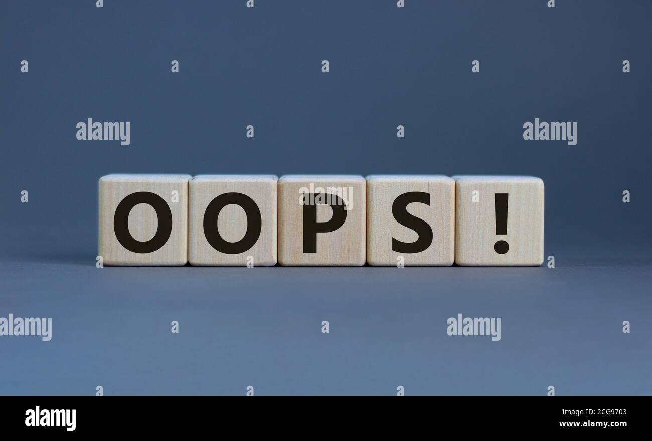 Oops sign on wooden cubes. Beautiful grey background, copy space ...