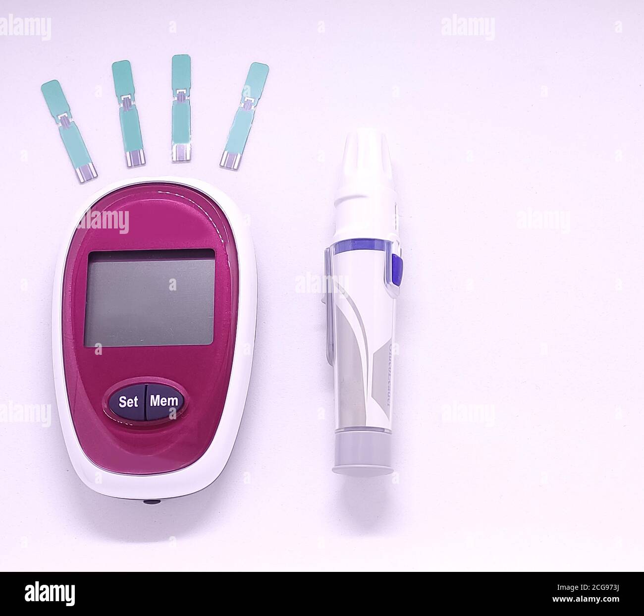The glucometer with test strips on white background in concept of ...