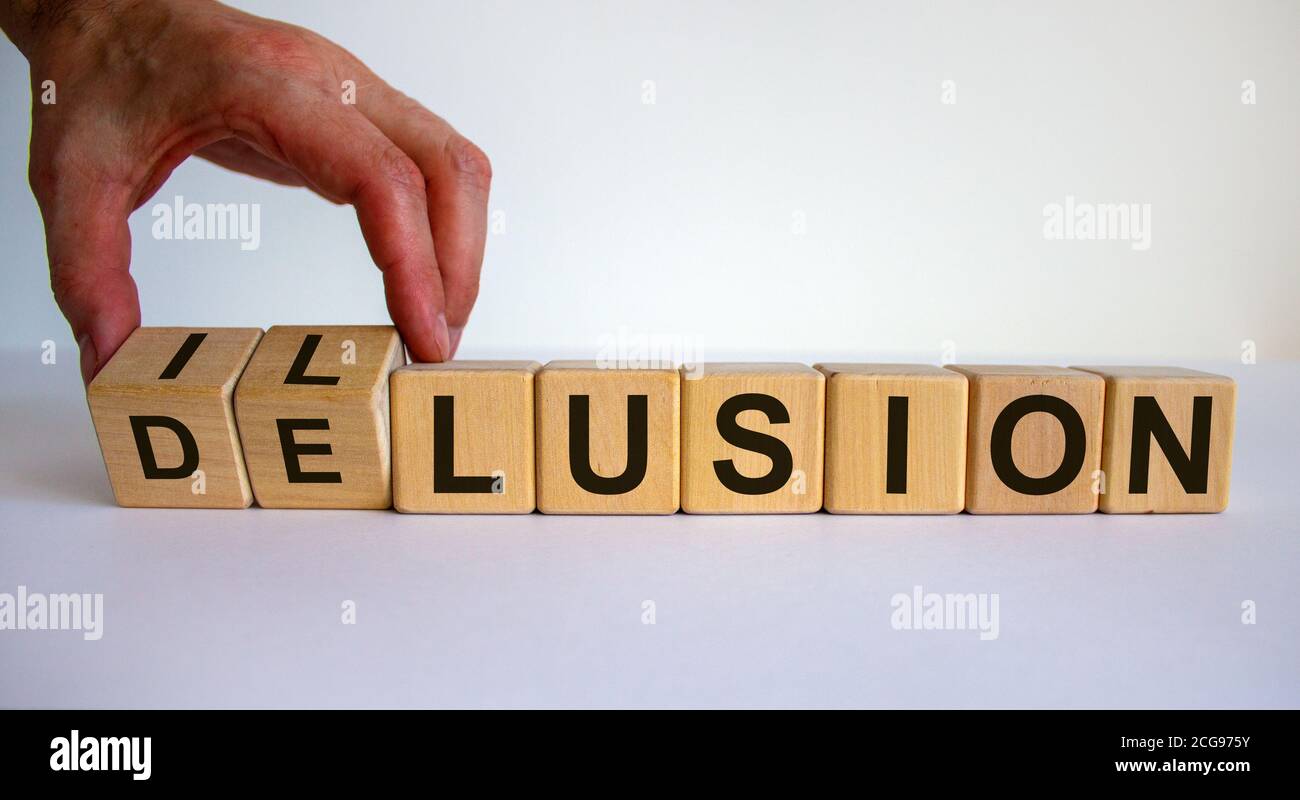 Hand turns a cube and changes the word delusion to illusion. Beautiful ...