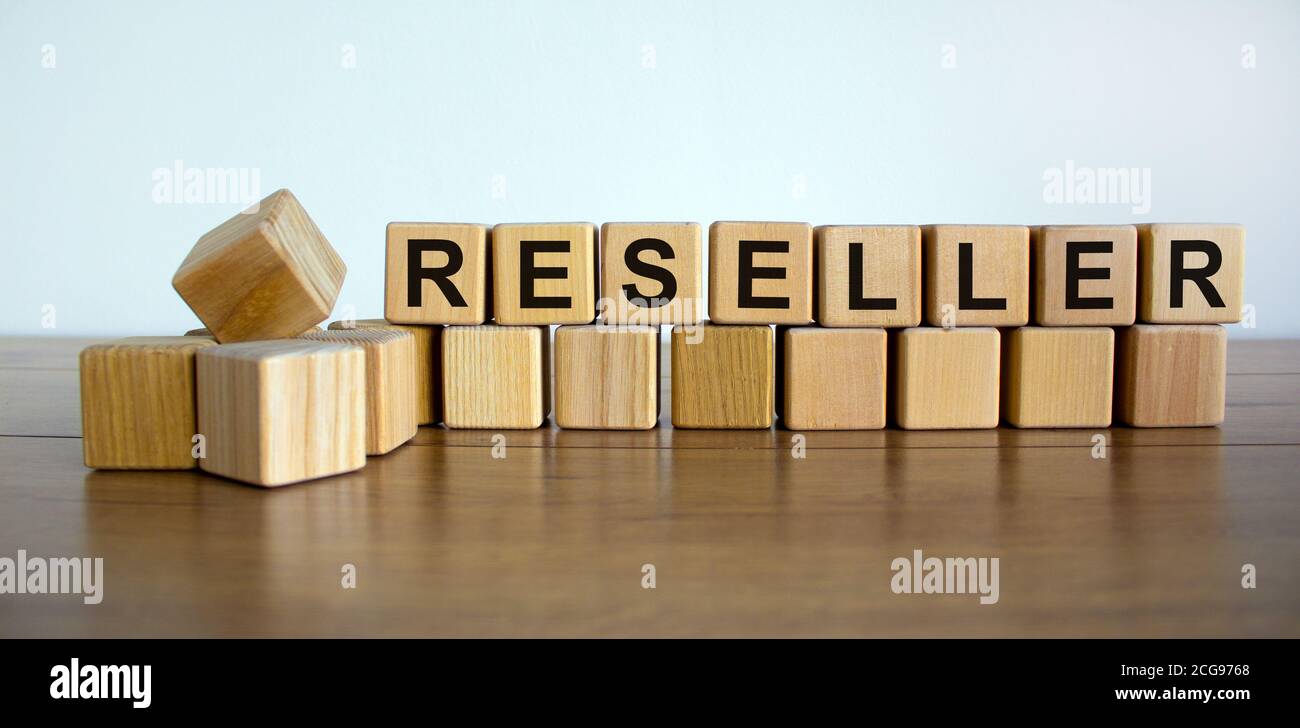 Wooden blocks form the word 'reseller'. Beautiful wooden table, white ...