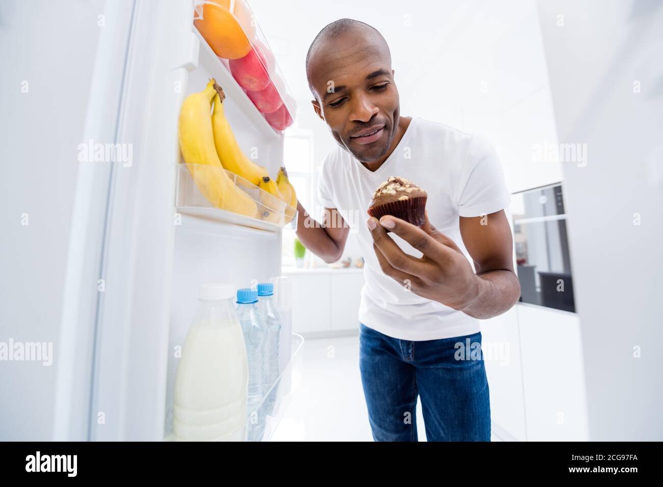 Portrait of his he nice attractive hungry guy looking in fridge taking ...