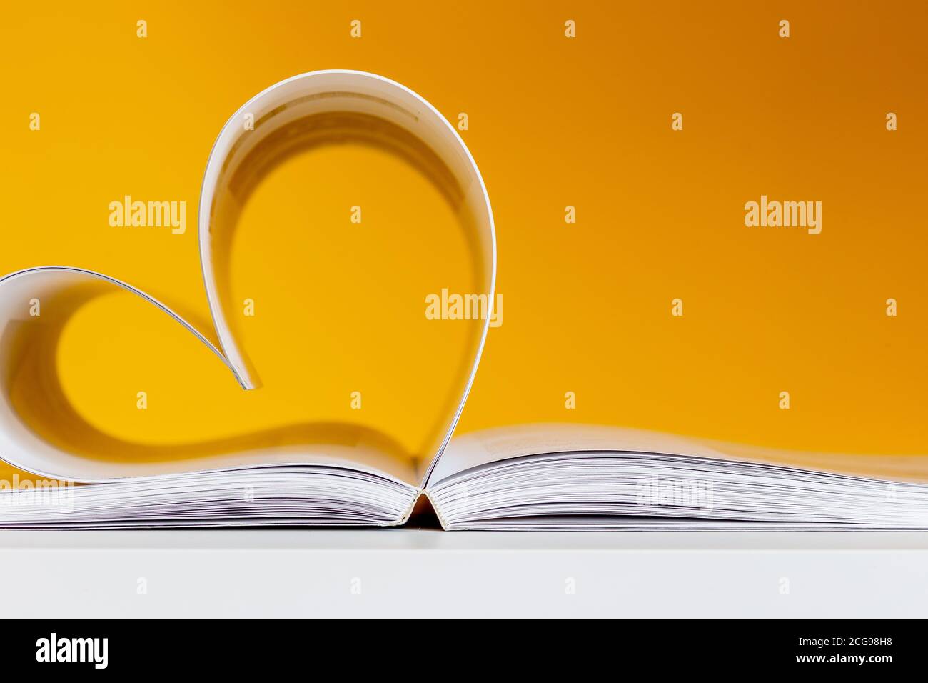 heart-shaped pages, love to read concept Stock Photo - Alamy