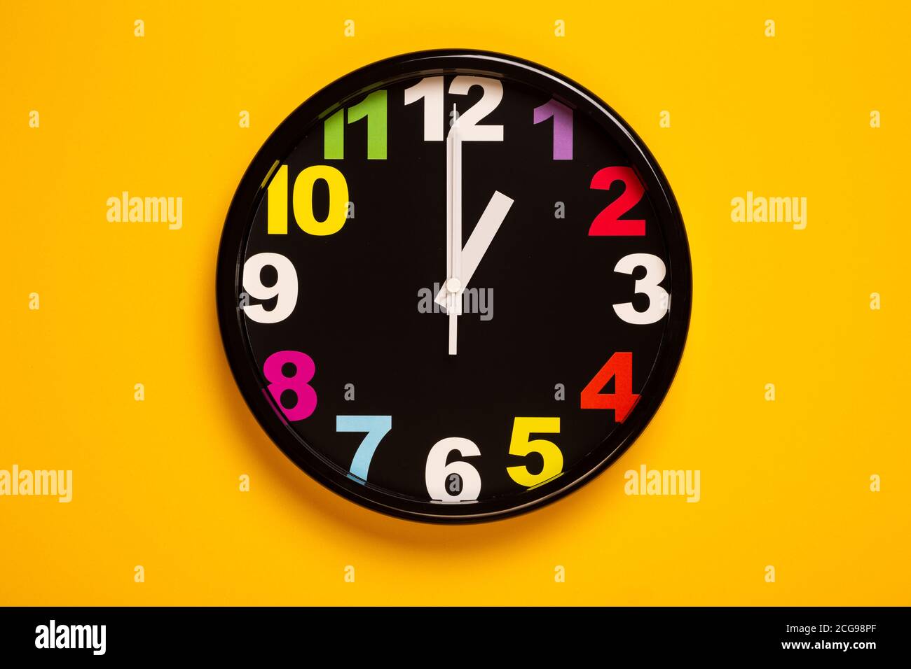 colorful wall clock show one o'clock Stock Photo - Alamy
