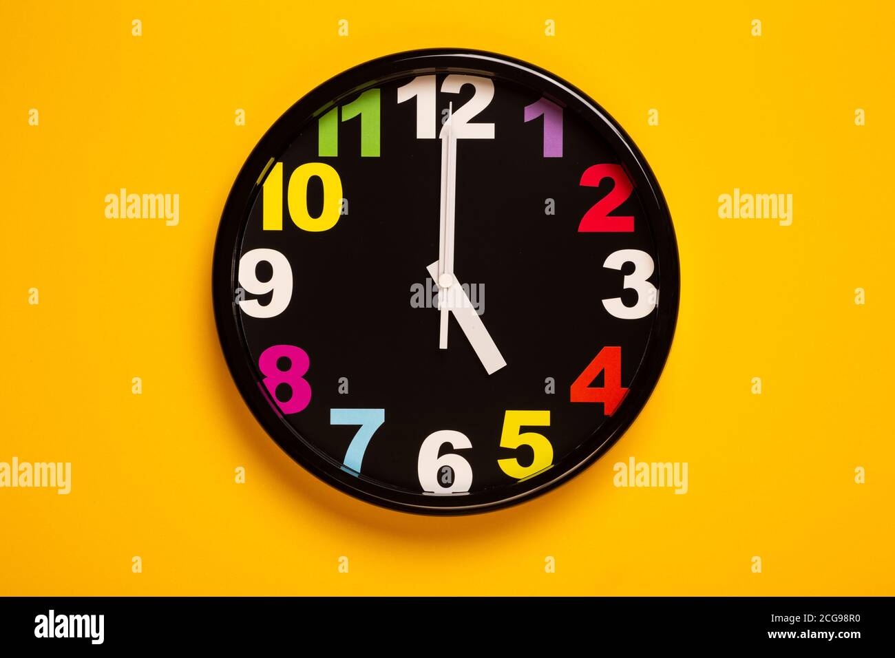 colorful wall clock show five o'clock Stock Photo - Alamy