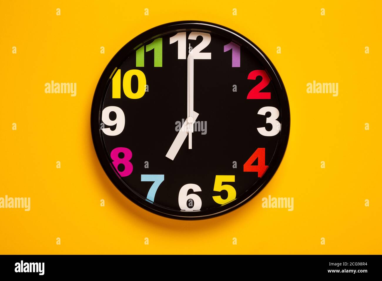 colorful wall clock show seven o'clock Stock Photo - Alamy