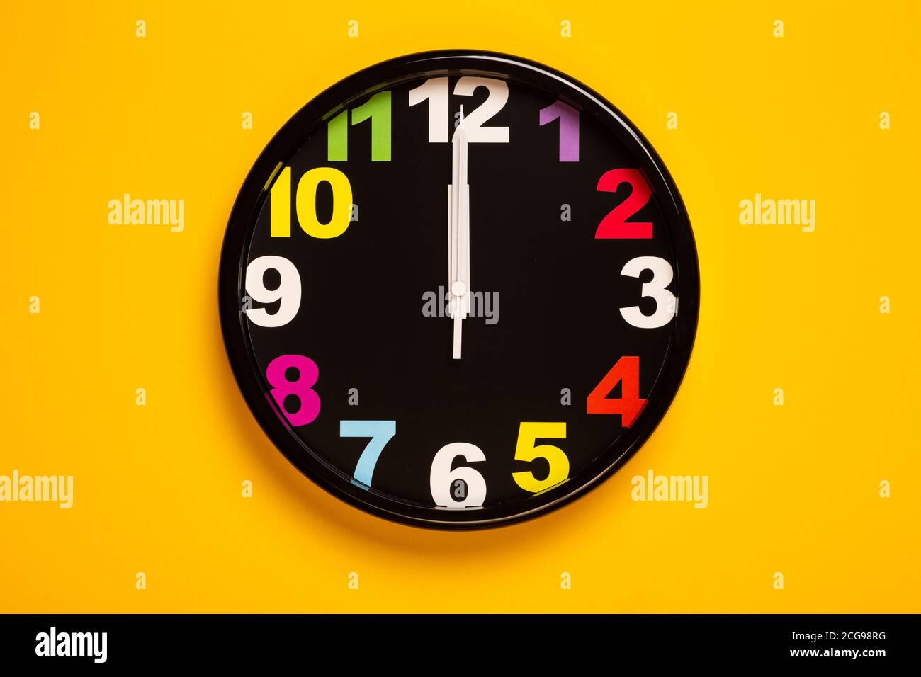 colorful wall clock show twelve o'clock Stock Photo - Alamy