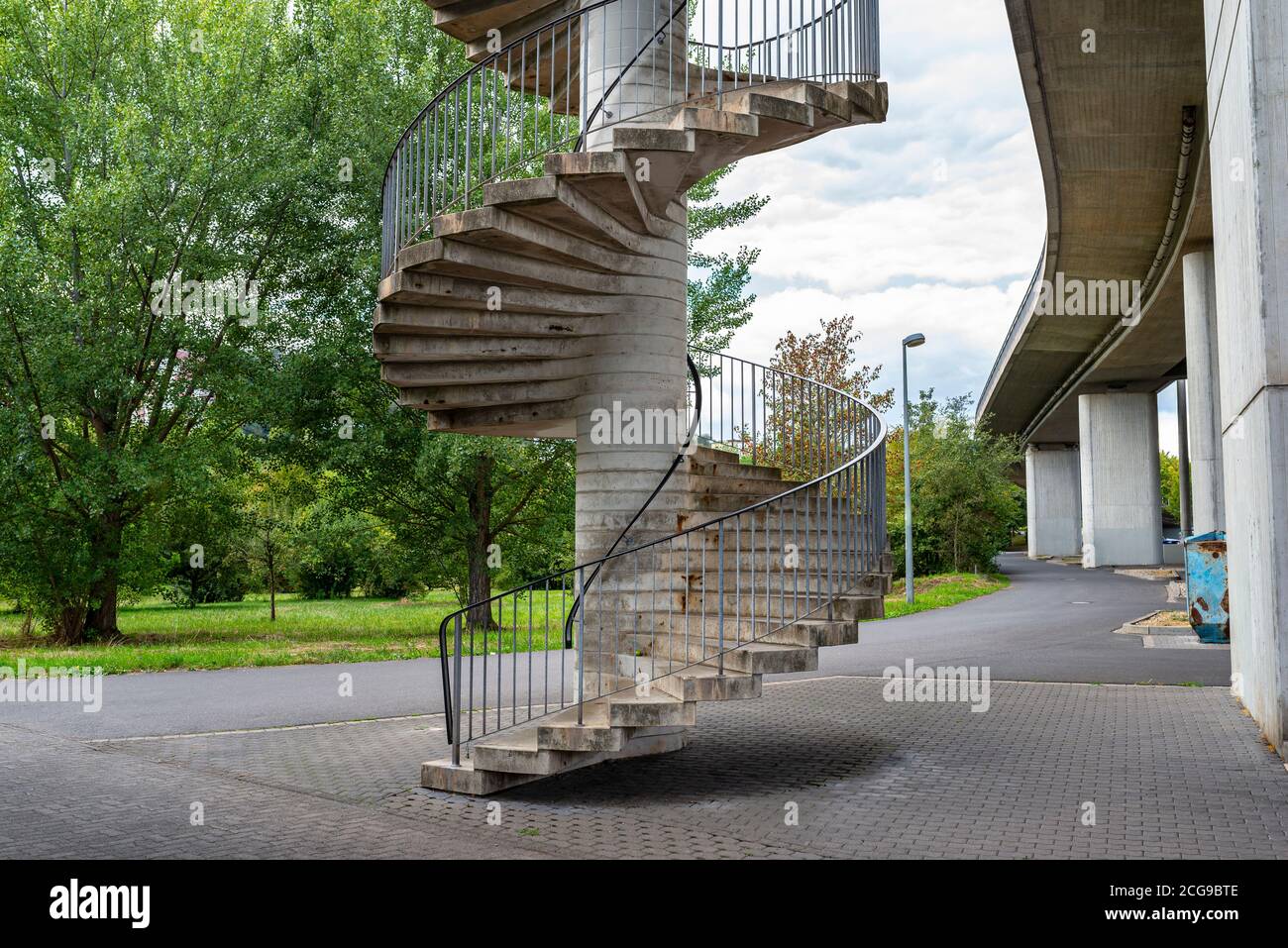 Concrete spiral staircase with metal handrails for pedestrian traffic ...