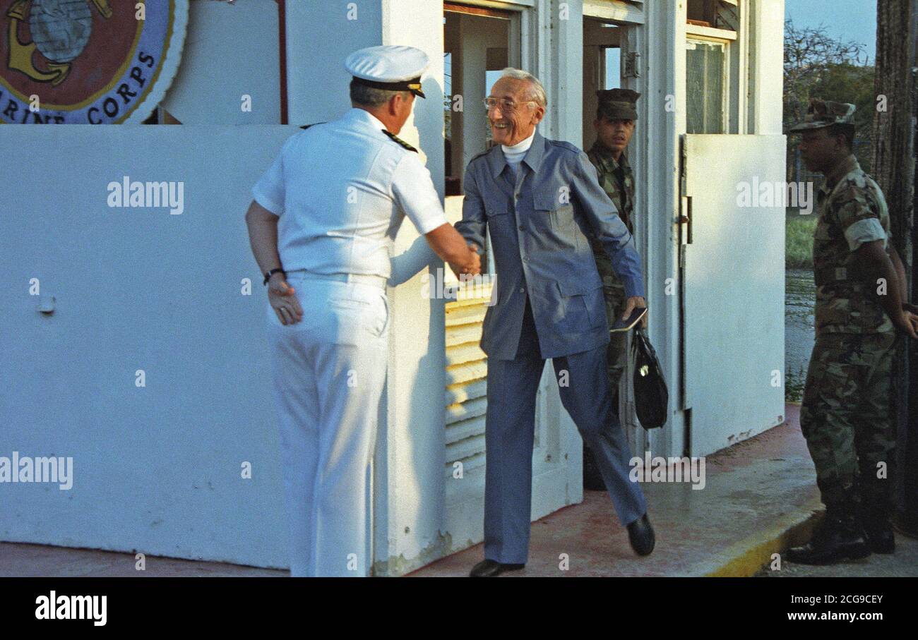 Explorer Jacques Cousteau is greeted by a US Navy officer after passing ...