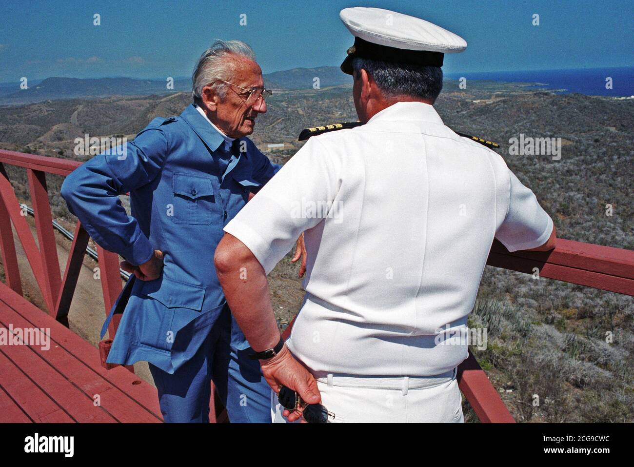 Explorer Jacques Cousteau speaks with a US Navy officer after arriving ...