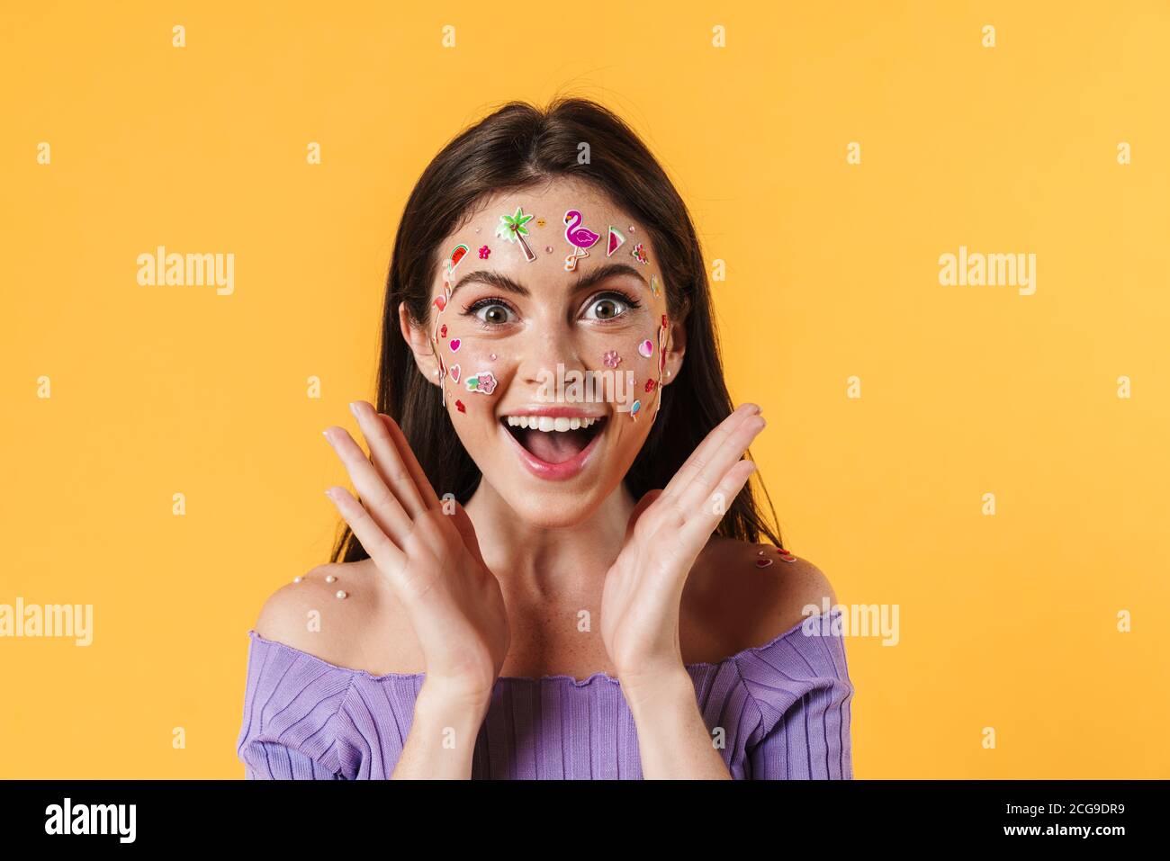 Image of delighted woman with stickers on face expressing surprise on ...