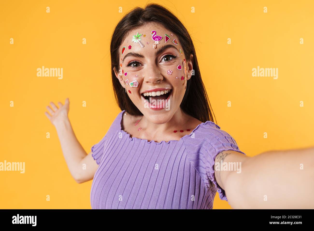 Image of happy woman with stickers on face showing copyspace while ...
