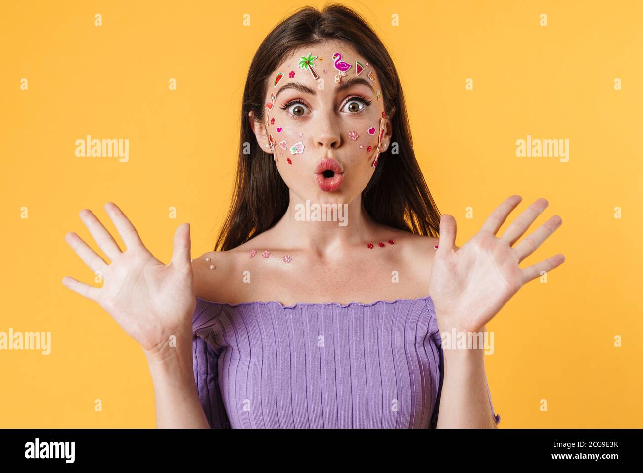 Image of delighted woman with stickers on face expressing surprise on ...