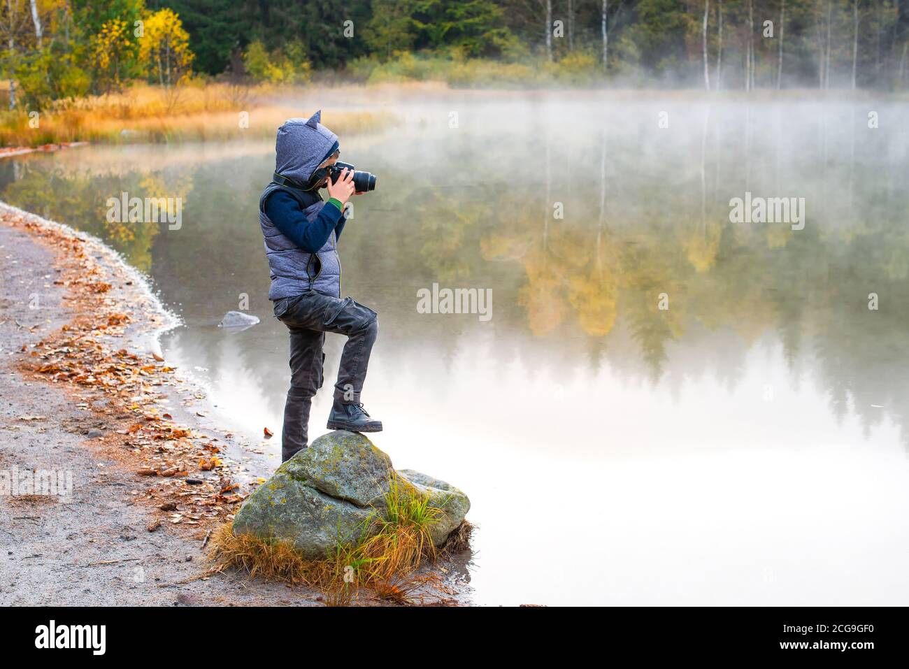 Creative child, kid photographer (a little boy) with a camera taking ...