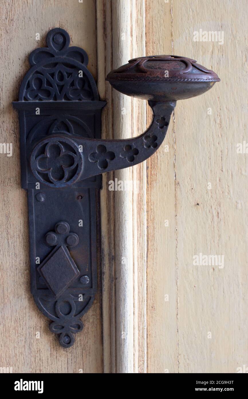 Historic old metal door handle on a wooden door Stock Photo - Alamy