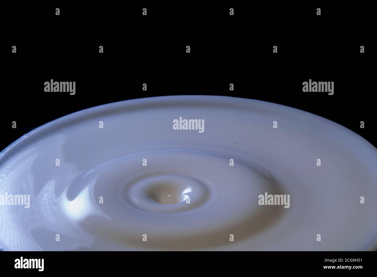 Milk waves on a cup full of milk Stock Photo - Alamy