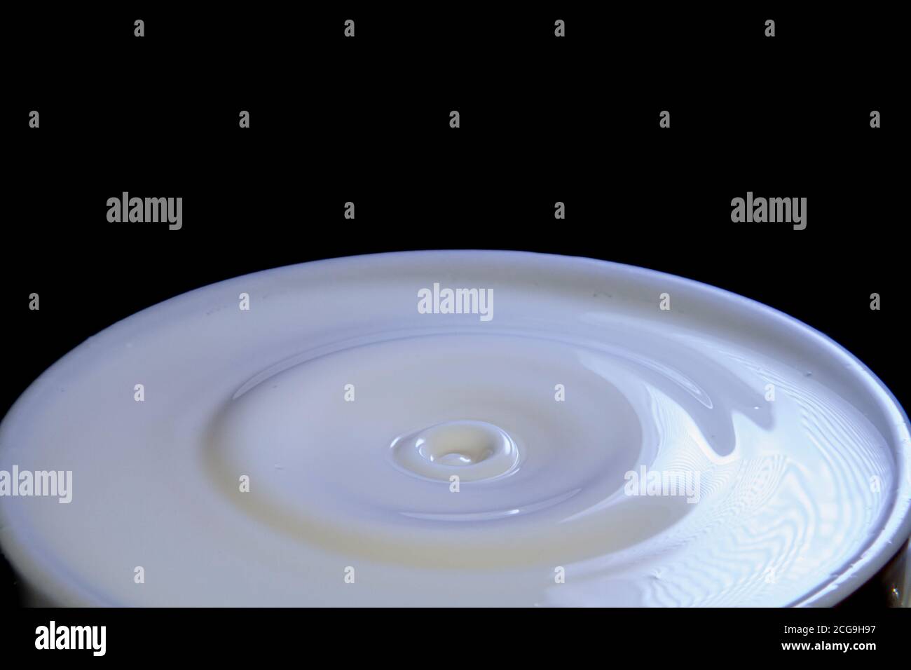 Milk waves on a cup full of milk Stock Photo - Alamy