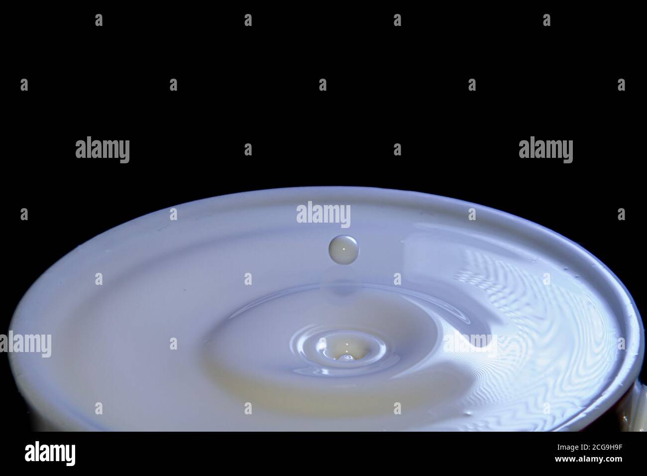 Milk waves on a cup full of milk Stock Photo - Alamy