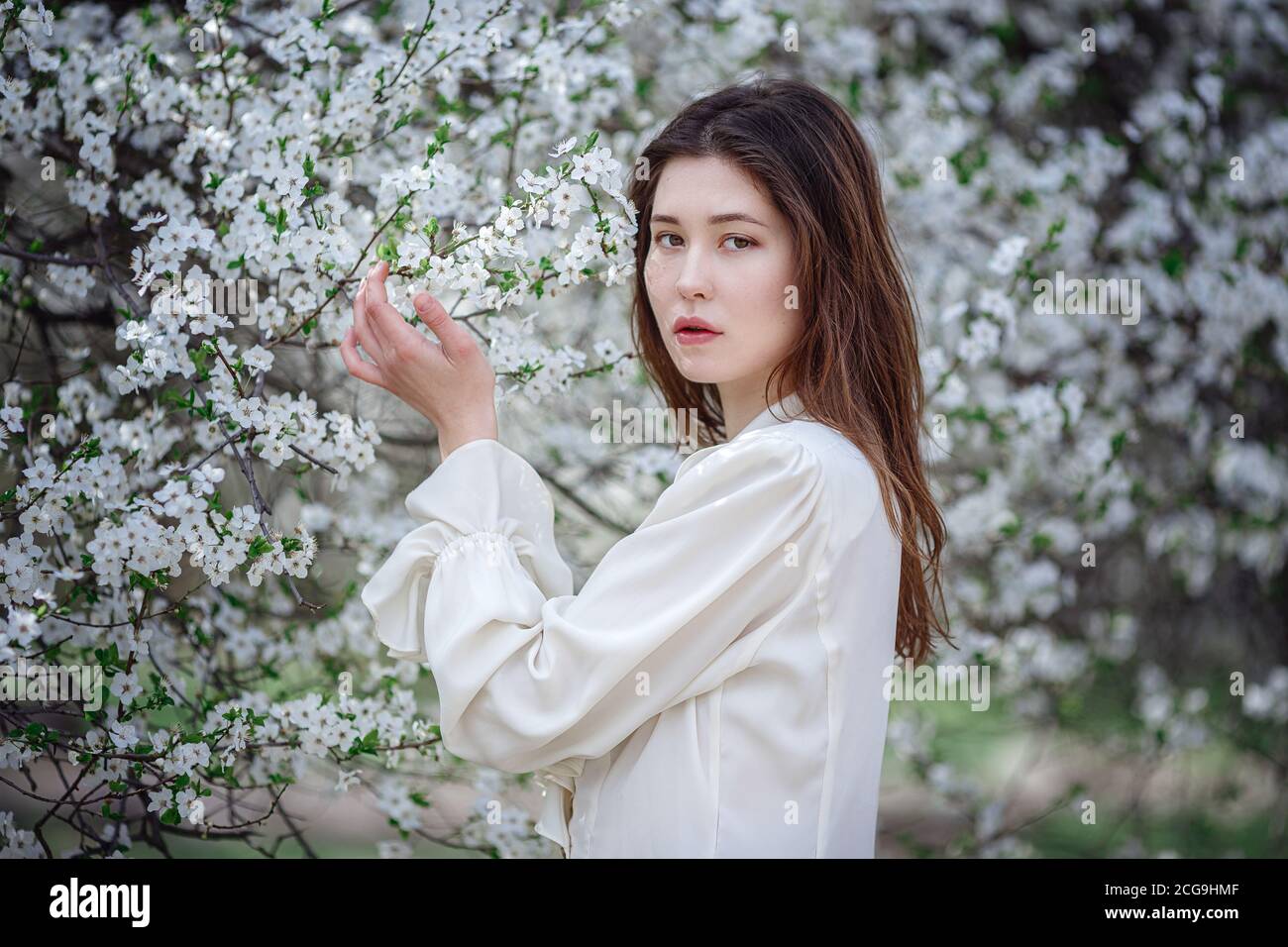 young asian woman in a flowering garden. romantic image of stylish ...