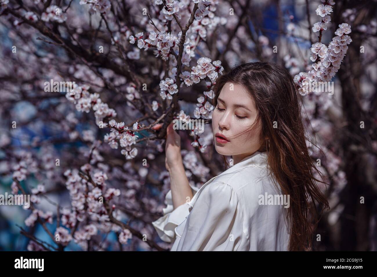 young asian woman in a flowering garden. romantic image of stylish ...