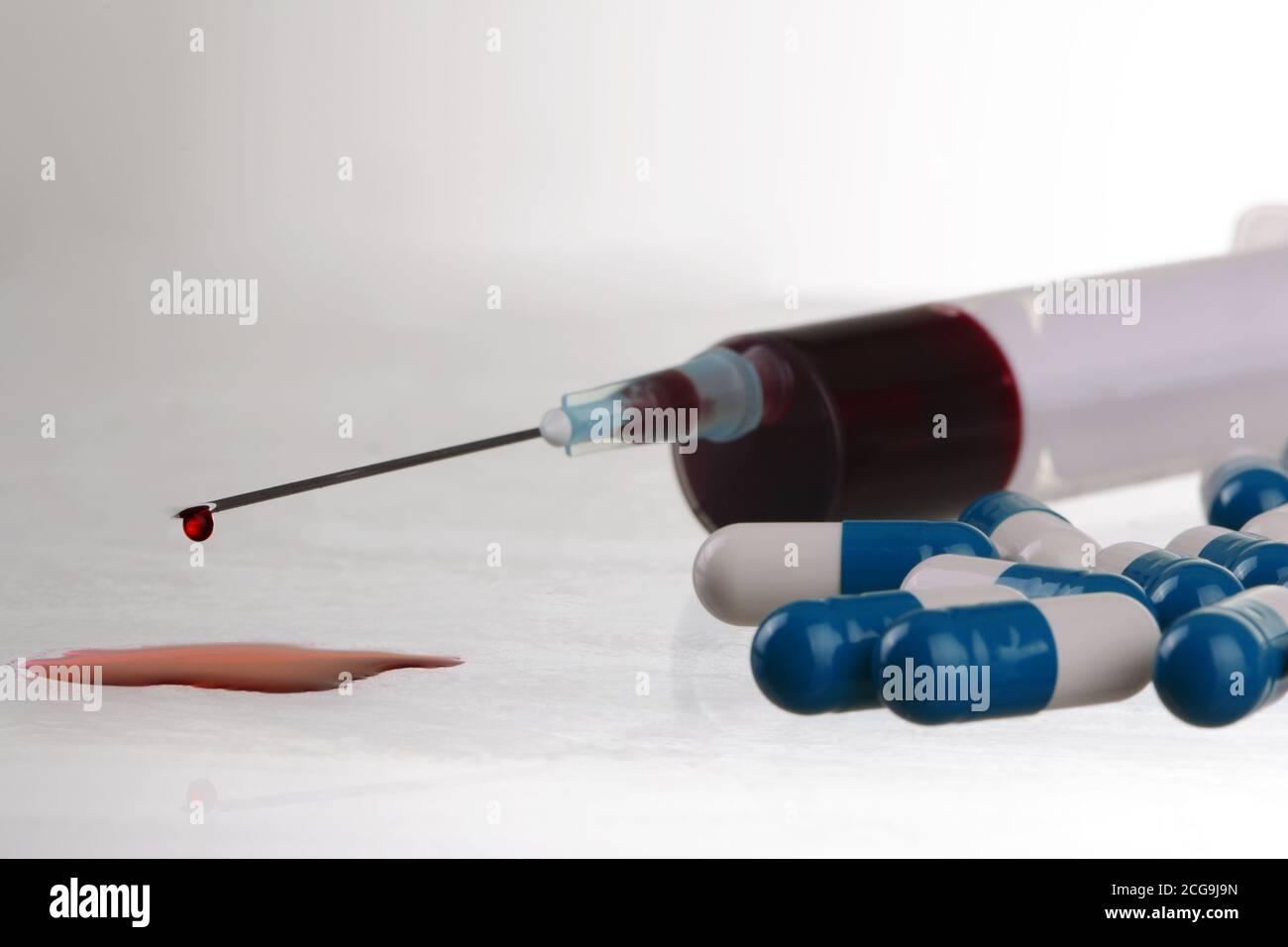 Injection syringe shot red fluid hi-res stock photography and images ...