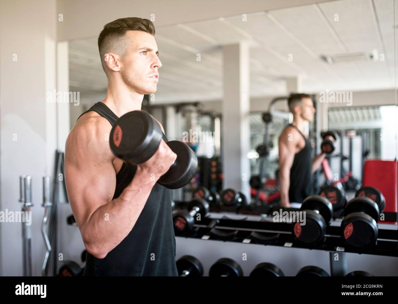 Man training biceps in gym hi-res stock photography and images - Alamy