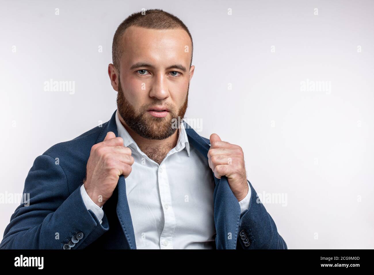 A confident caucasian bearded handsome mid-aged man in formal suit ...