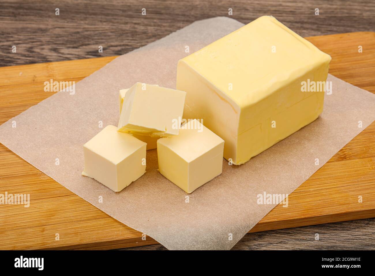 Dairy natural yellow butter piece over board Stock Photo - Alamy