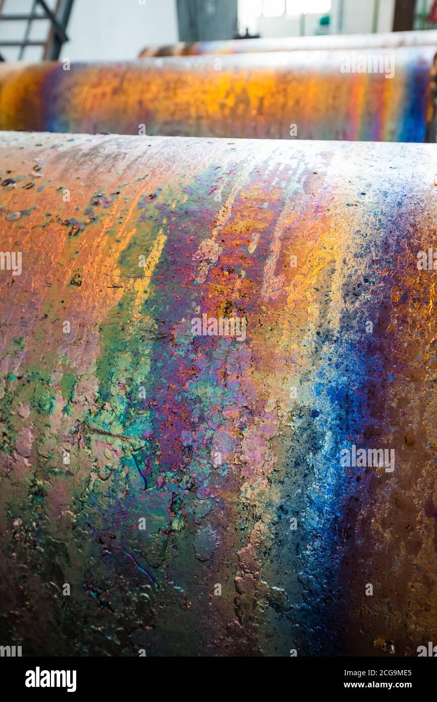 Titanium cylinder before mechanical metalwork on turning lathe. Color ...